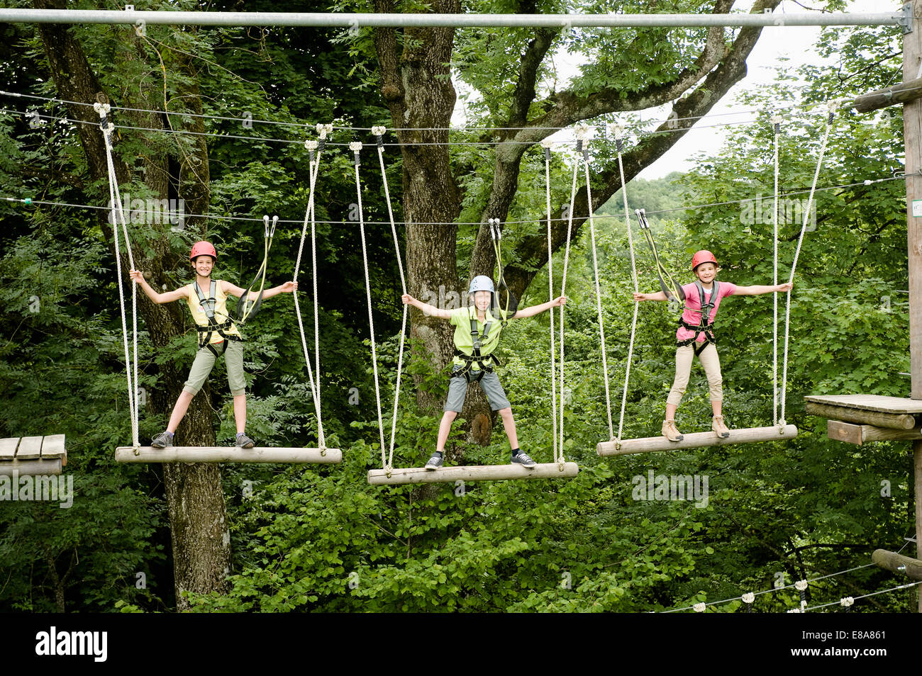 Boys and girl climbing crag Stock Photo - Alamy