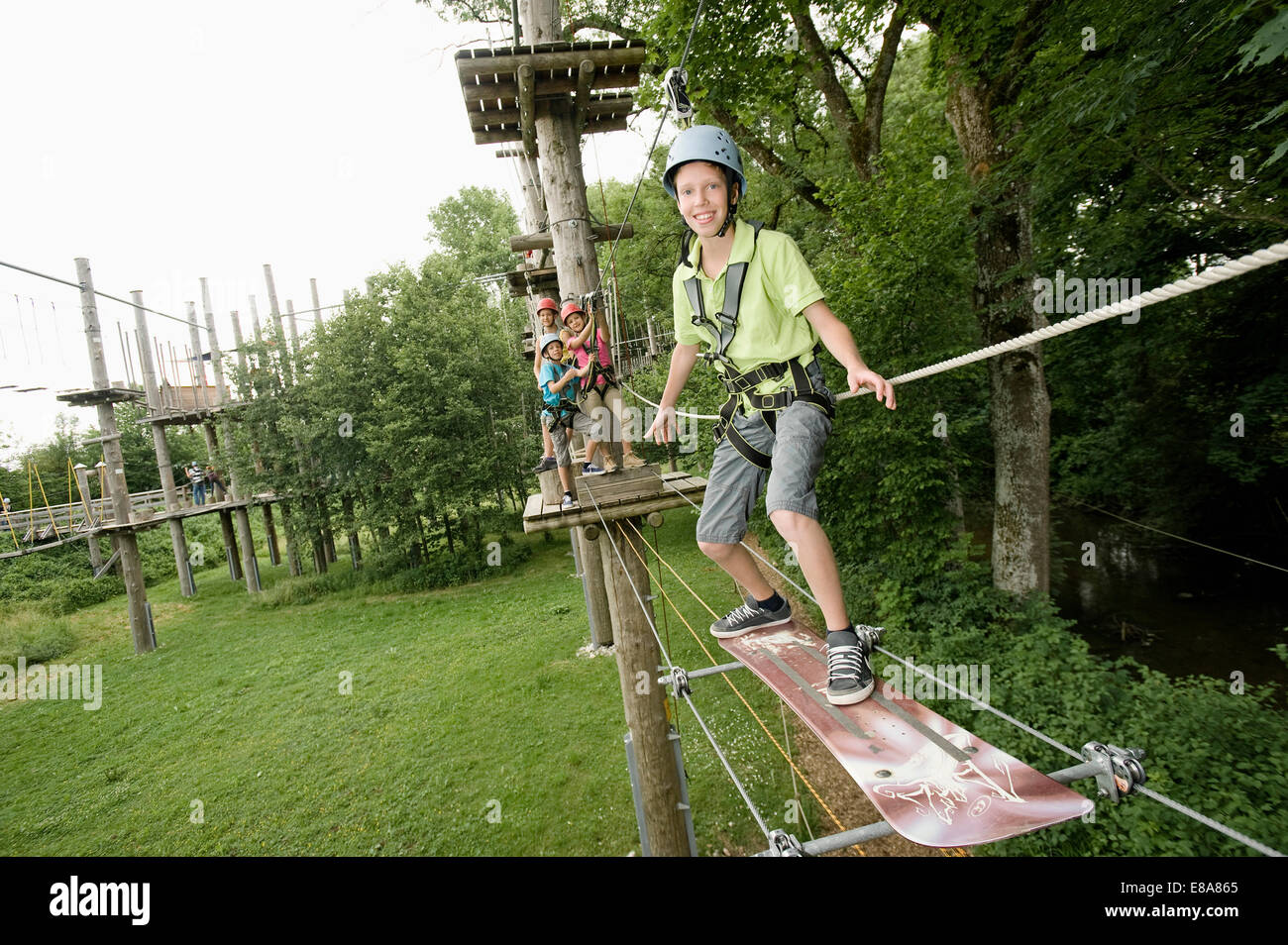 Boys and girls climbing crag, smiling Stock Photo - Alamy