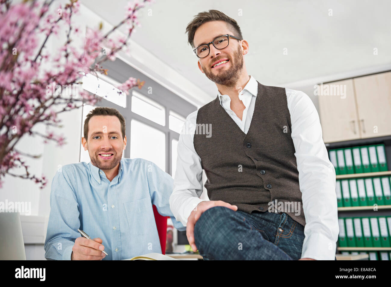 Portrait two men young business colleagues smiling Stock Photo - Alamy