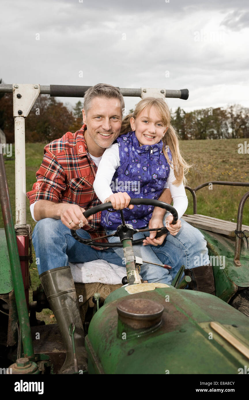 Farmer daughter on tractor hi-res stock photography and images - Alamy