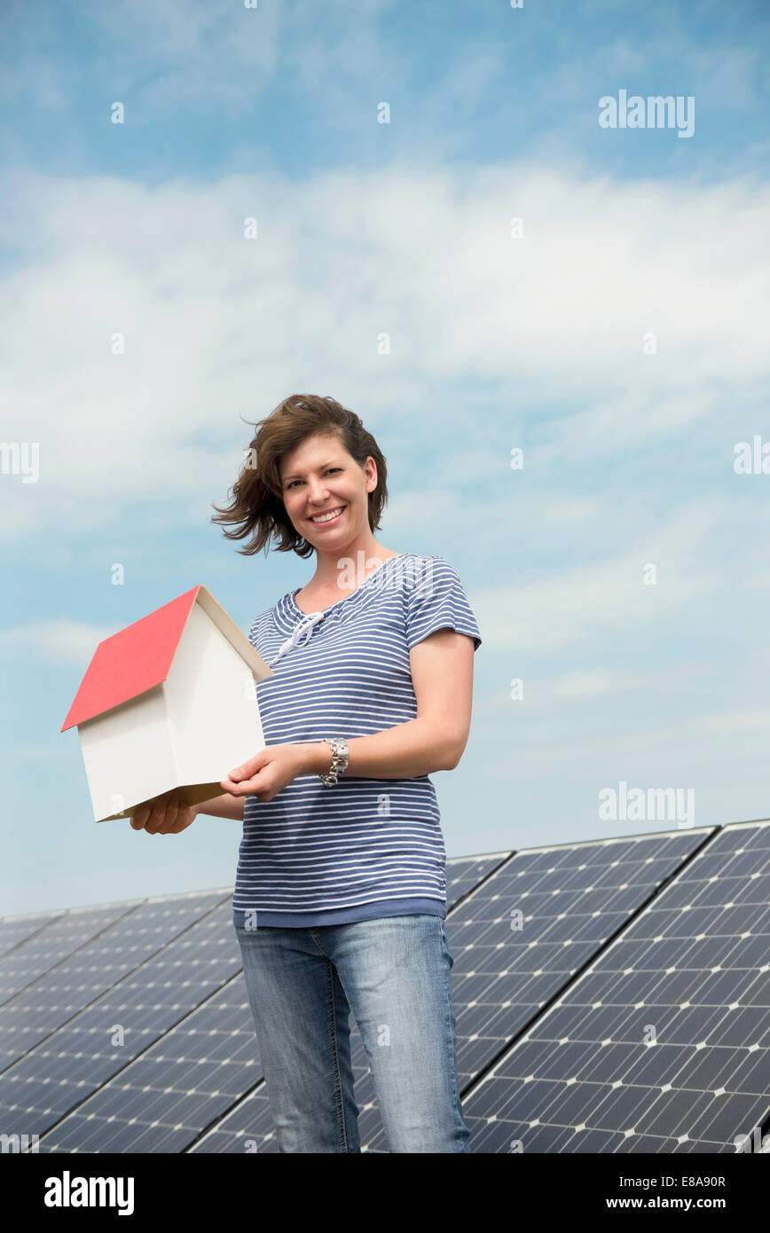 Photovoltaic panel woman holding model house Stock Photo - Alamy
