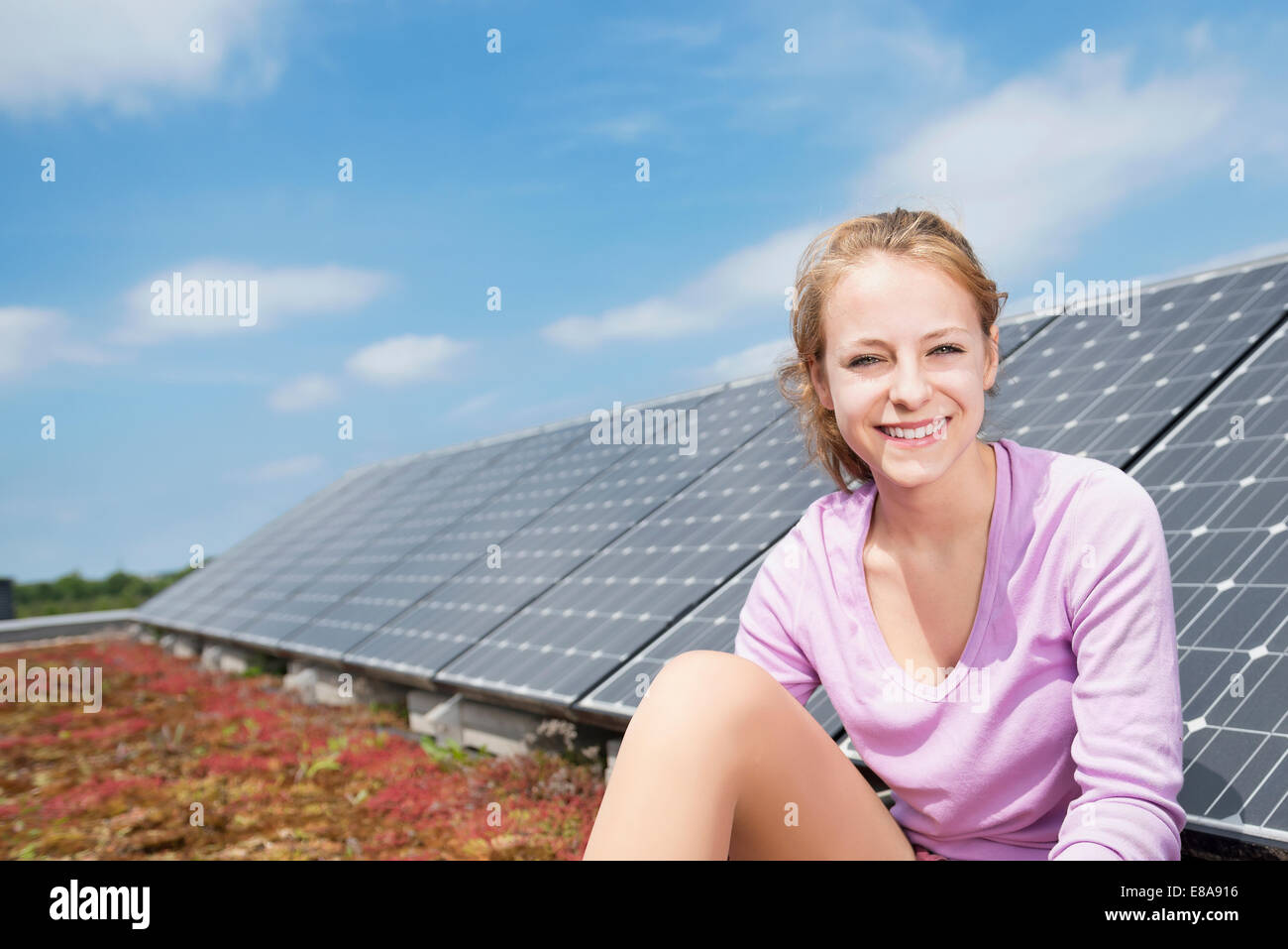 Teenage girl renewable energy solar panel Stock Photo - Alamy