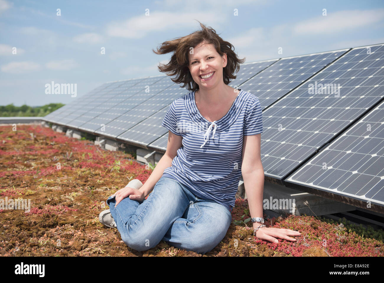 Portrait young woman in front of solar panel Stock Photo - Alamy