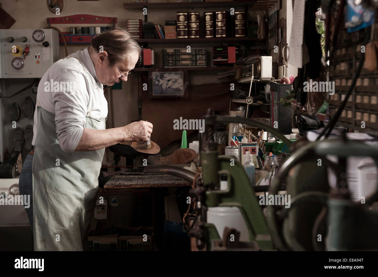 Cobbler working in workshop Stock Photo - Alamy