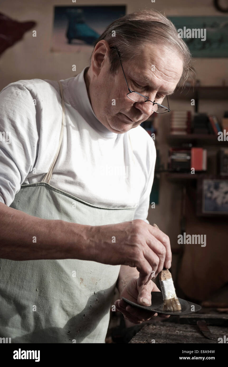 Cobbler working in workshop Stock Photo - Alamy