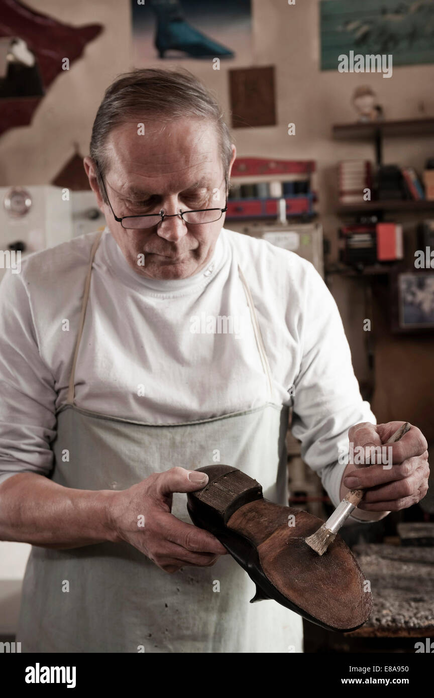 Cobbler working in workshop Stock Photo - Alamy