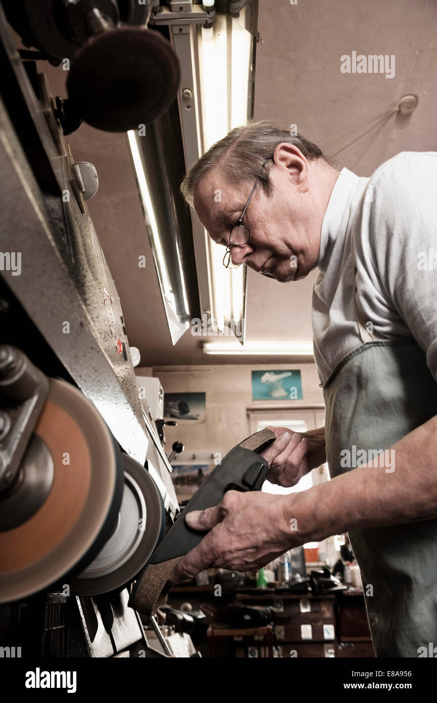 Cobbler working in workshop Stock Photo - Alamy