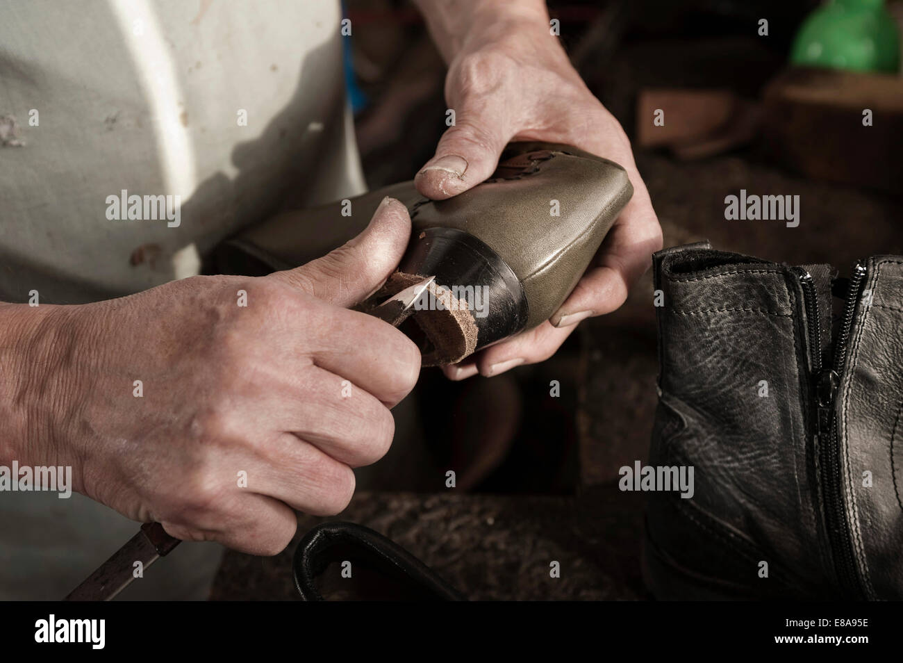 Cobbler working in workshop, close-up Stock Photo - Alamy
