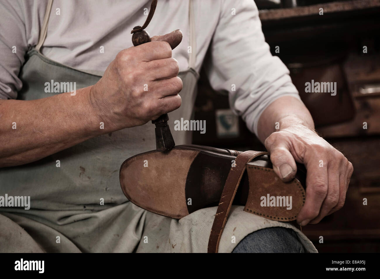 Cobbler working in workshop, close-up Stock Photo - Alamy