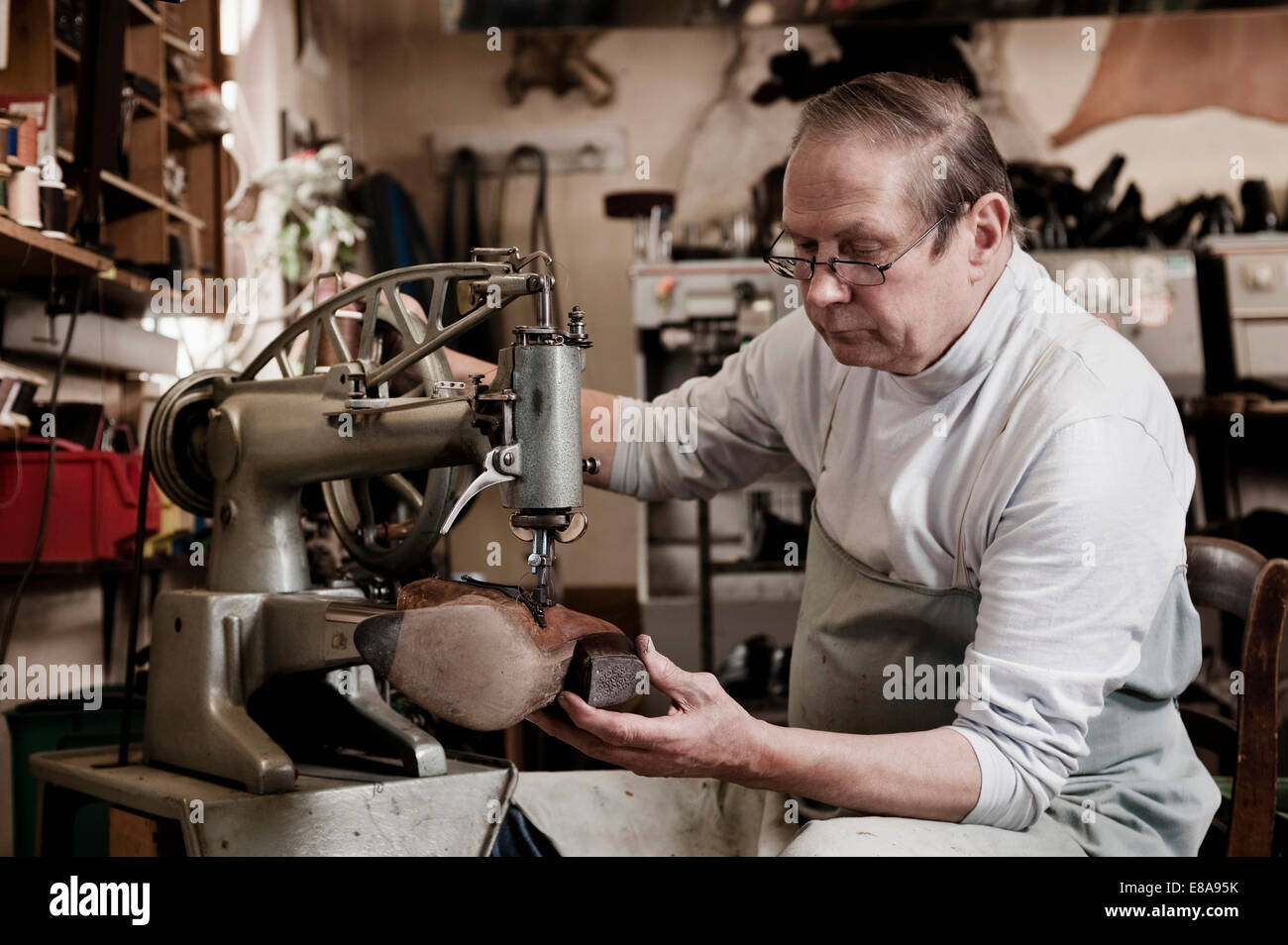 Cobbler working in workshop Stock Photo - Alamy