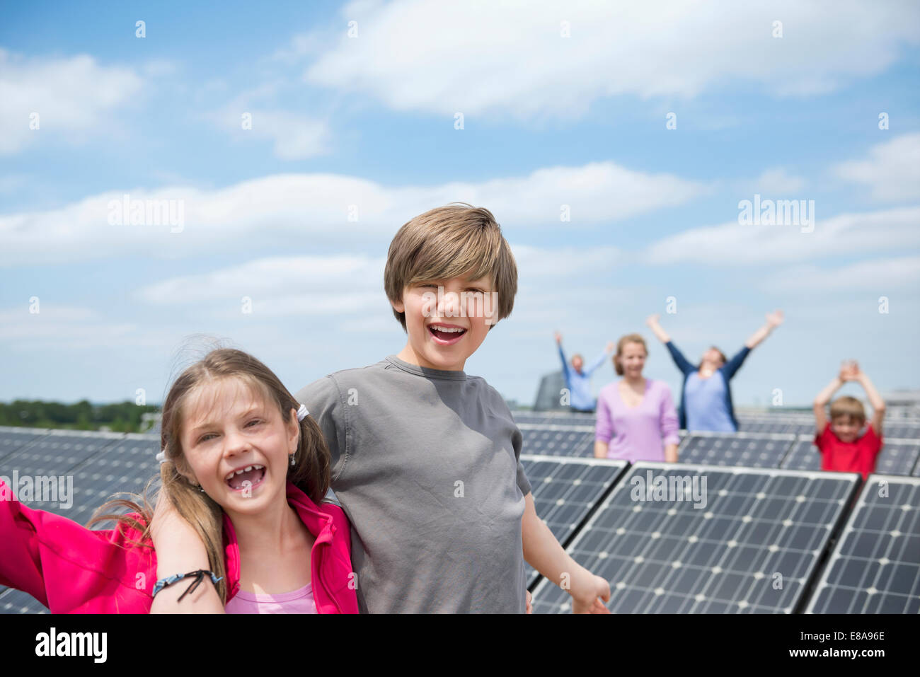 Family kids photo-voltaic park solar panel happy Stock Photo - Alamy