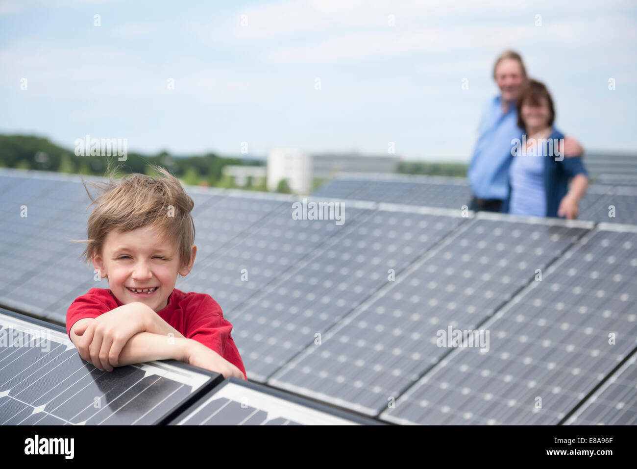 Boy leaning on solar panel photo-voltaic park Stock Photo - Alamy