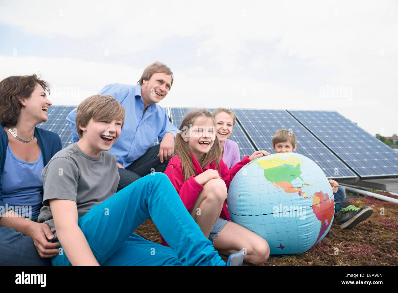 Family globe balloon solar energy smiling Stock Photo - Alamy