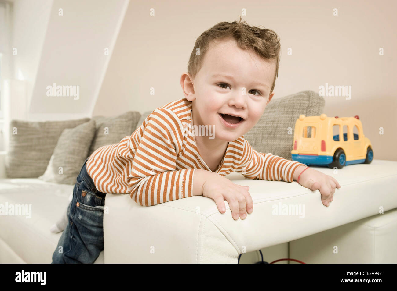 Portrait of boy playing with toys, smiling Stock Photo - Alamy