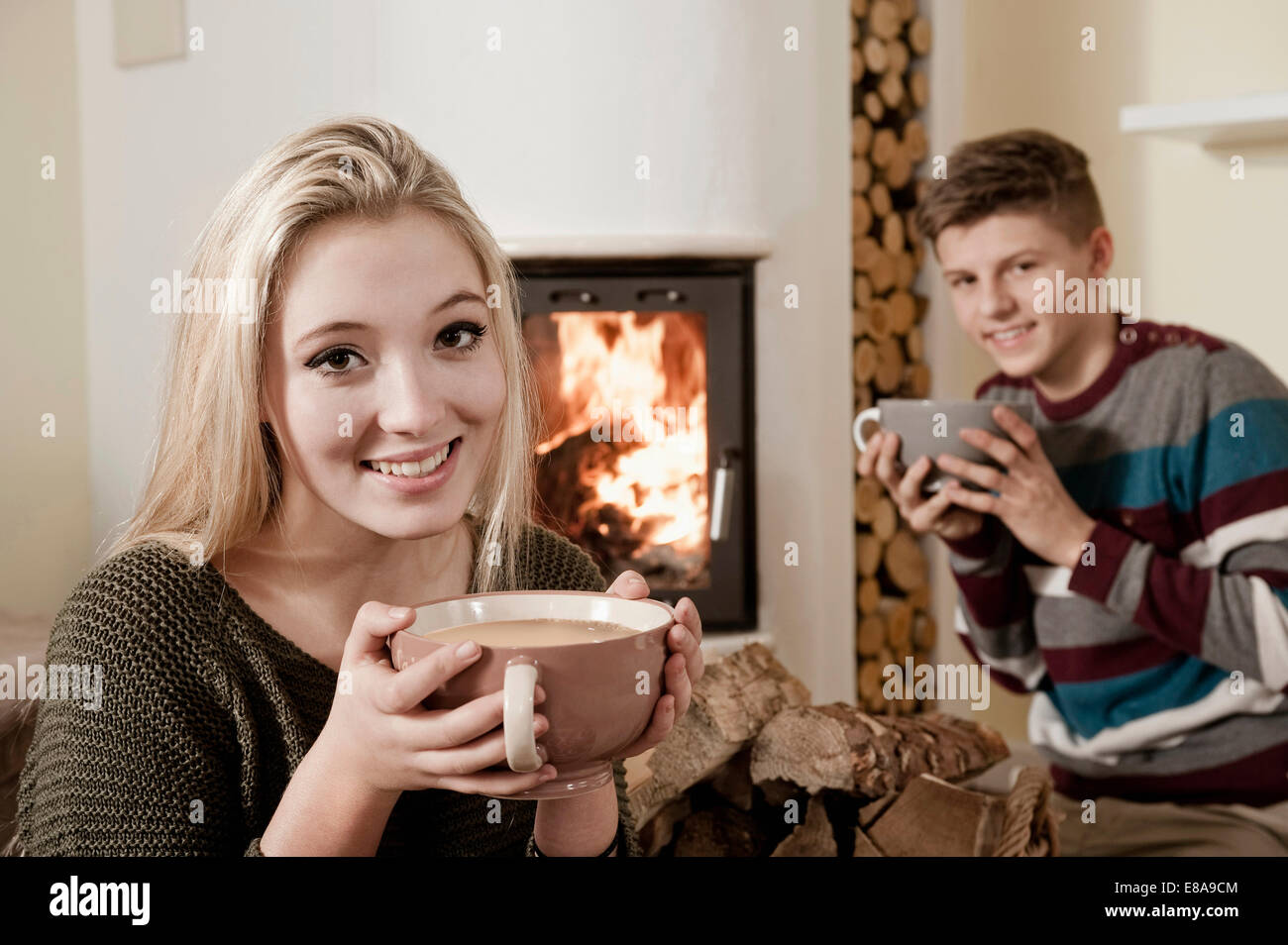 Young teenage couple first date log fire romantic Stock Photo - Alamy