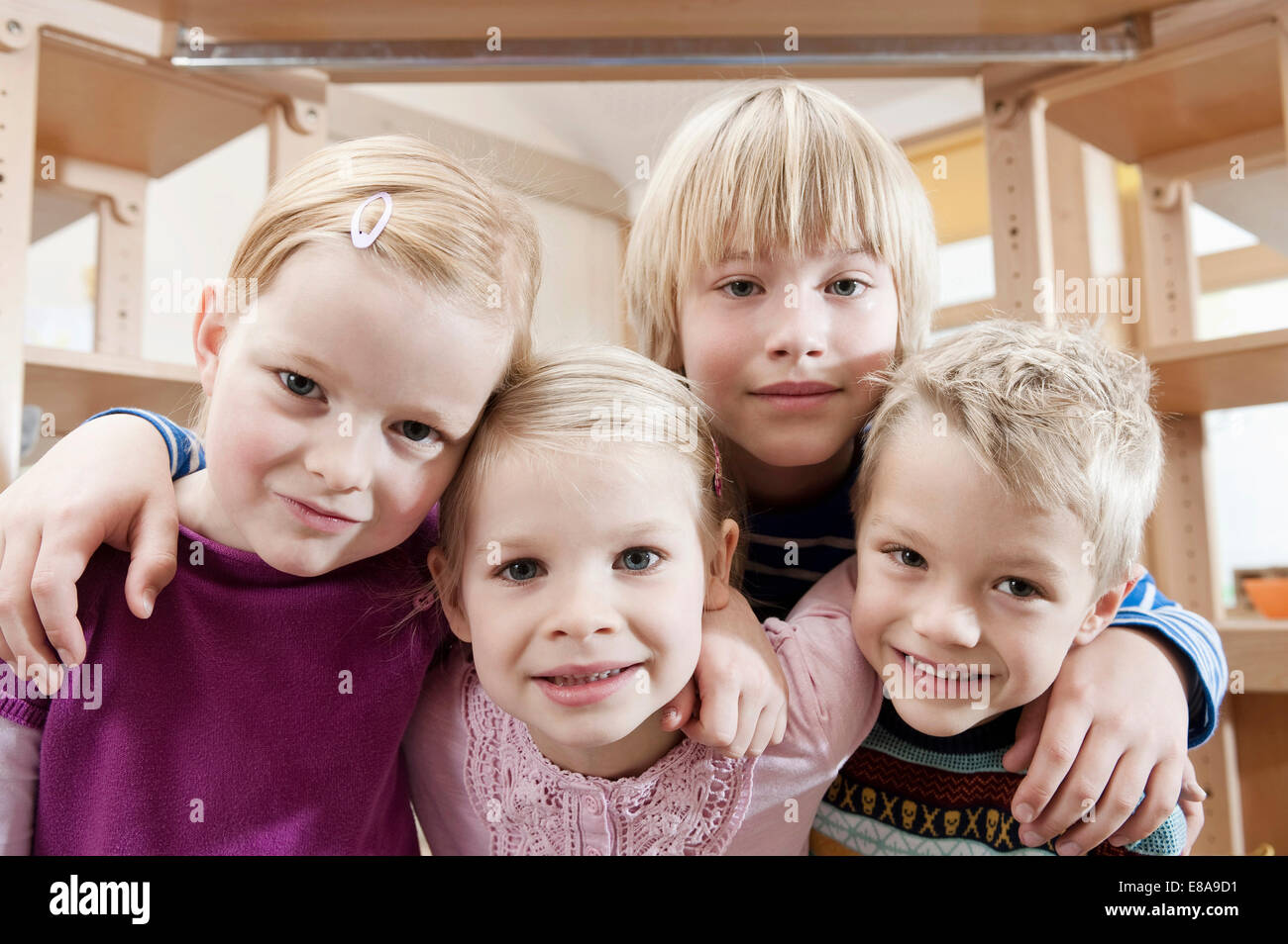 Group picture of four little child in kindergarten Stock Photo - Alamy