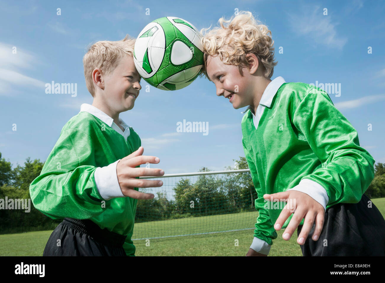 Two junior soccer players learning ball control Stock Photo - Alamy