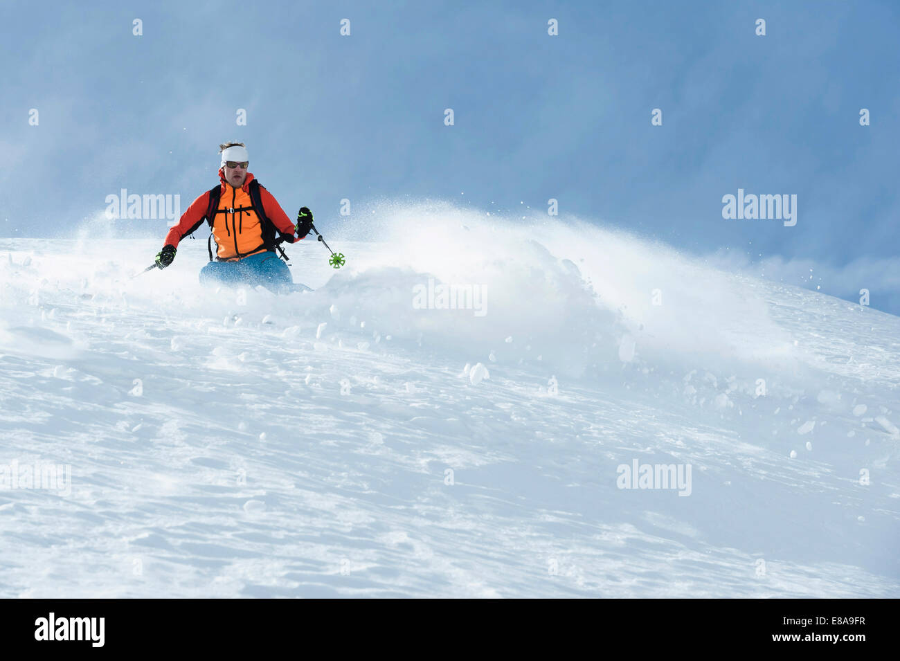 Man skiing downhill deep powder snow Alps Stock Photo - Alamy