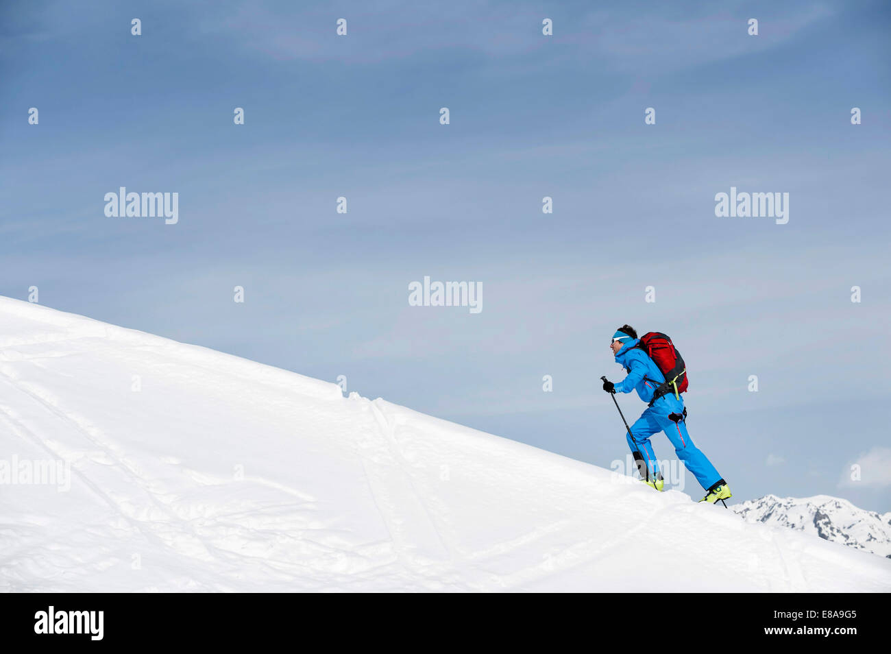 Man climbing ski slope mountain Alps snow winter Stock Photo - Alamy
