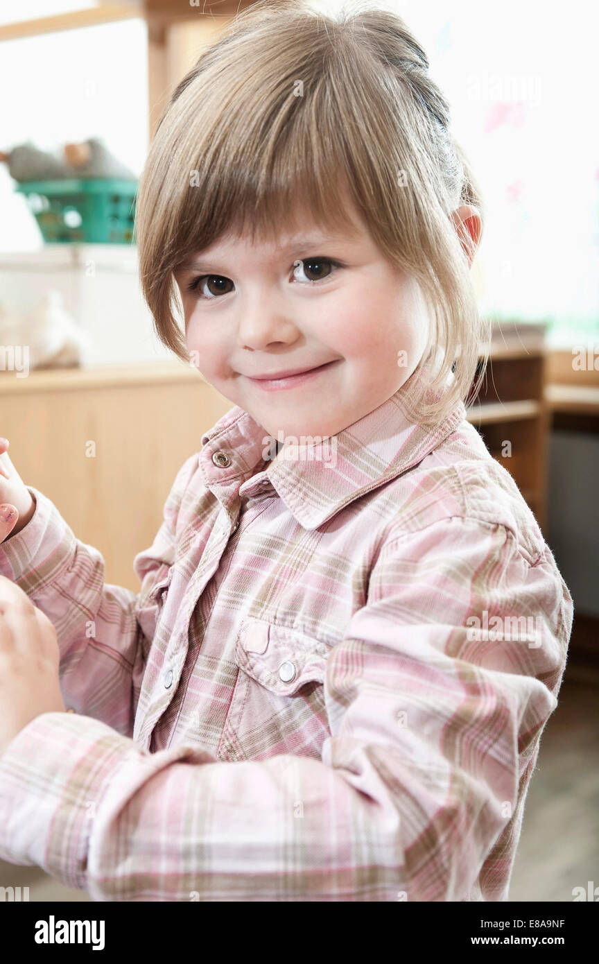 Portrait of smiling little girl in kindergarten Stock Photo - Alamy