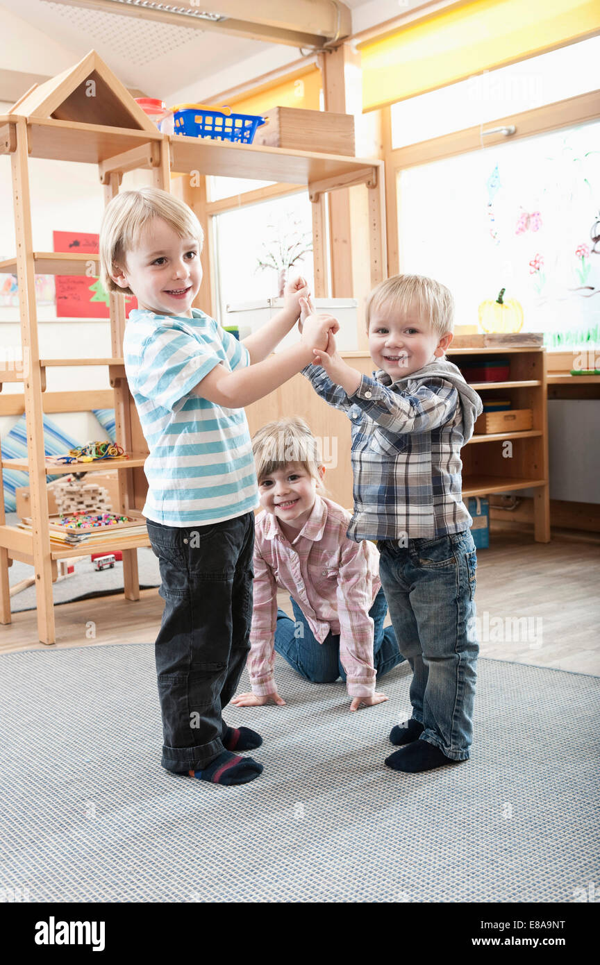 Three little kids in kindergarten Stock Photo - Alamy