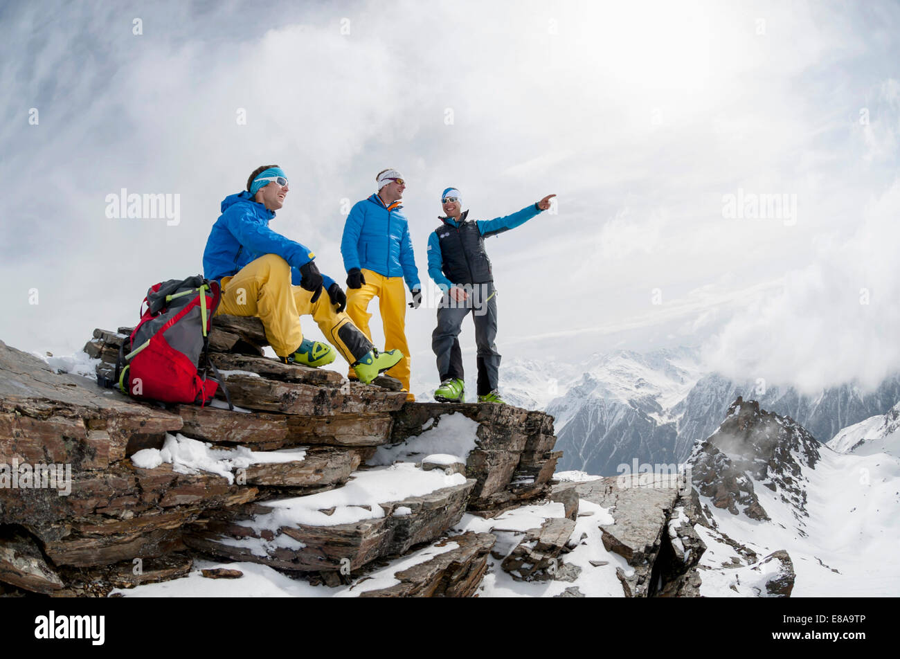 Three climbers skiers mountain peak alps snow Stock Photo - Alamy