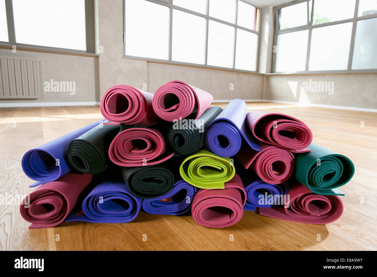 Yoga studio close up Pile of colorful mats Stock Photo - Alamy