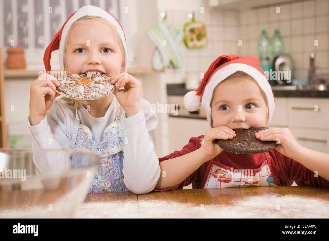 Girls eating gingerbread Stock Photo - Alamy