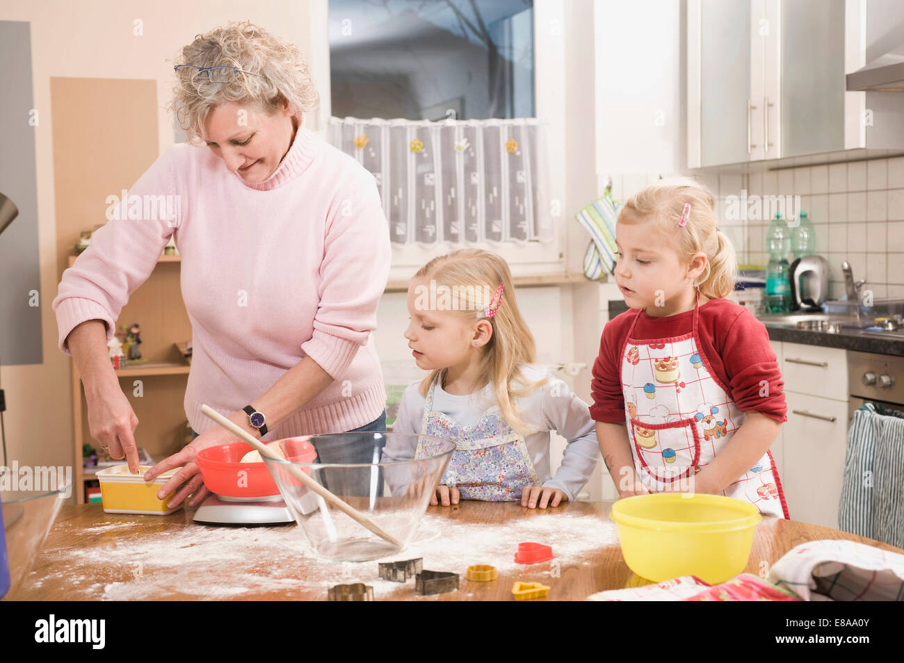 Family preparing cookies in kitchen Stock Photo - Alamy