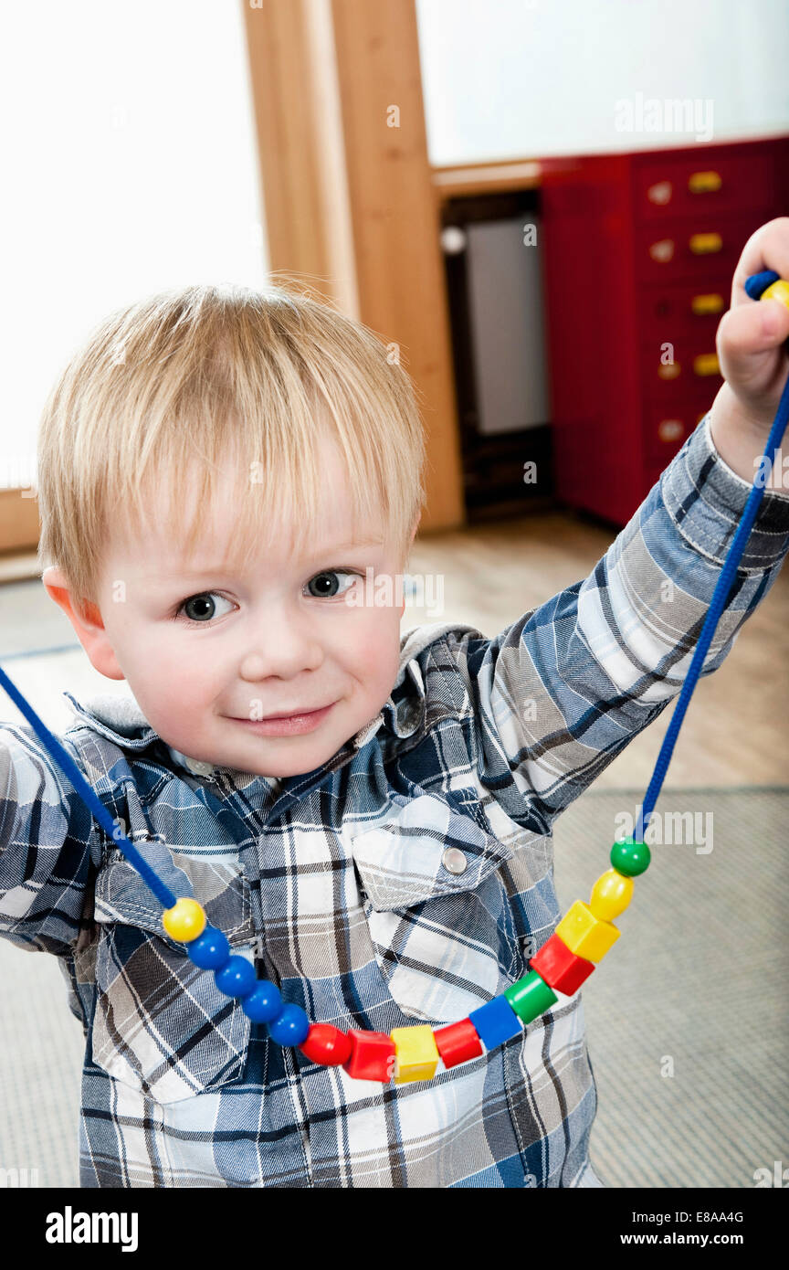 Proud little boy showing selfmade wooden perl necklace Stock Photo - Alamy Proud little boy showing selfmade wooden perl necklace Stock Photo - Alamy