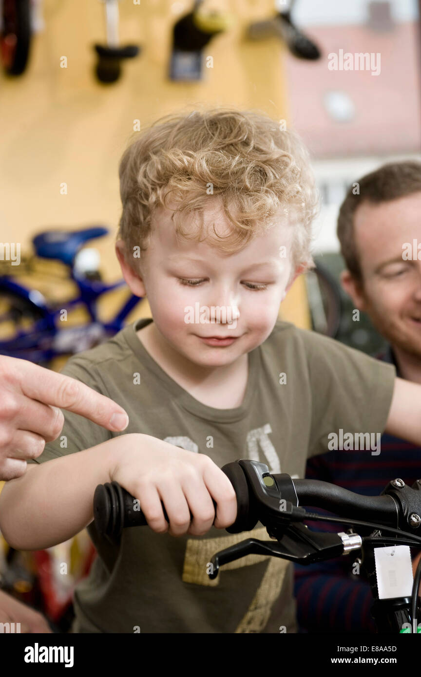 Boy getting a new children's bike Stock Photo - Alamy