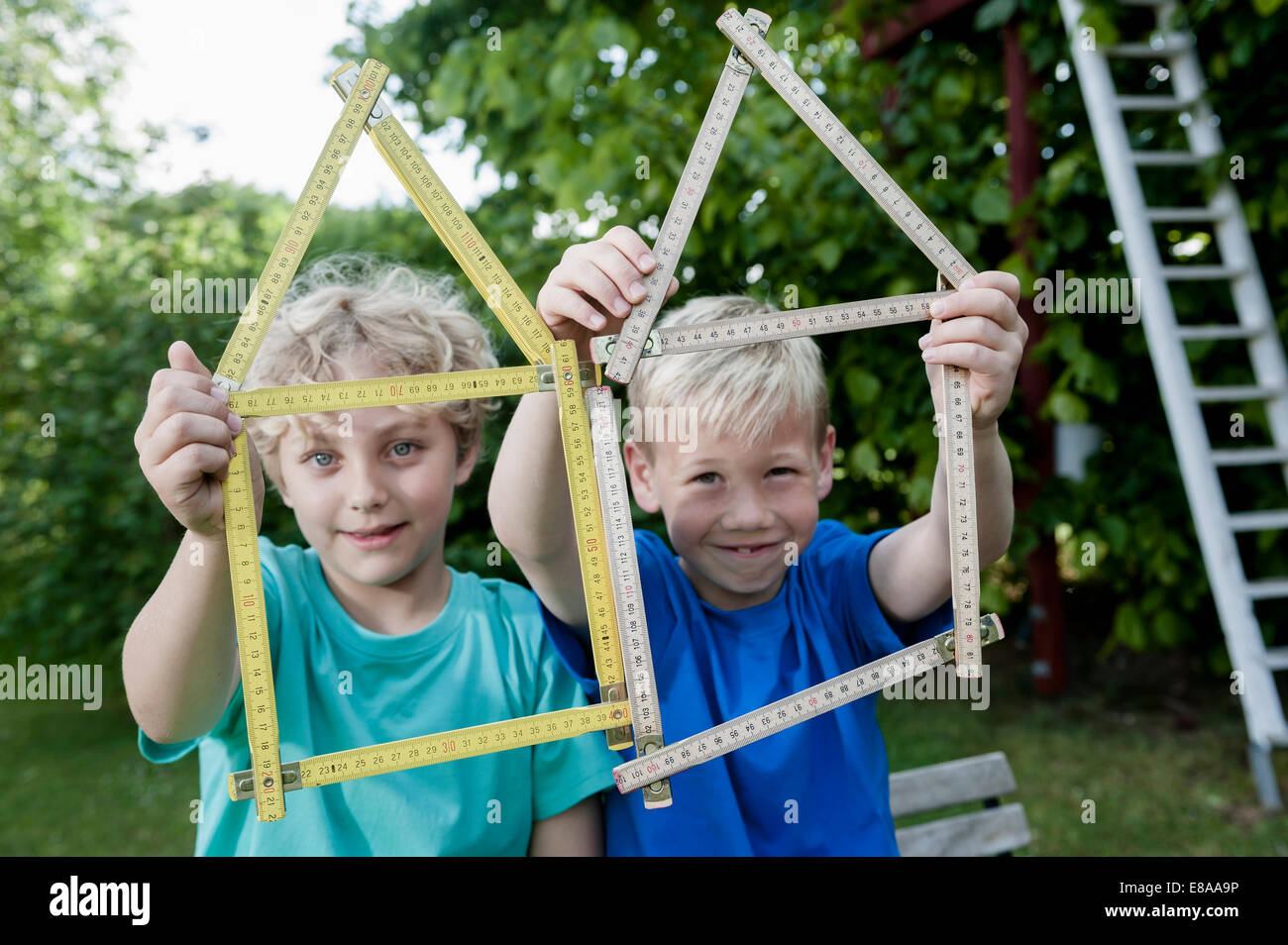 Close up two boys house shape ruler Stock Photo - Alamy