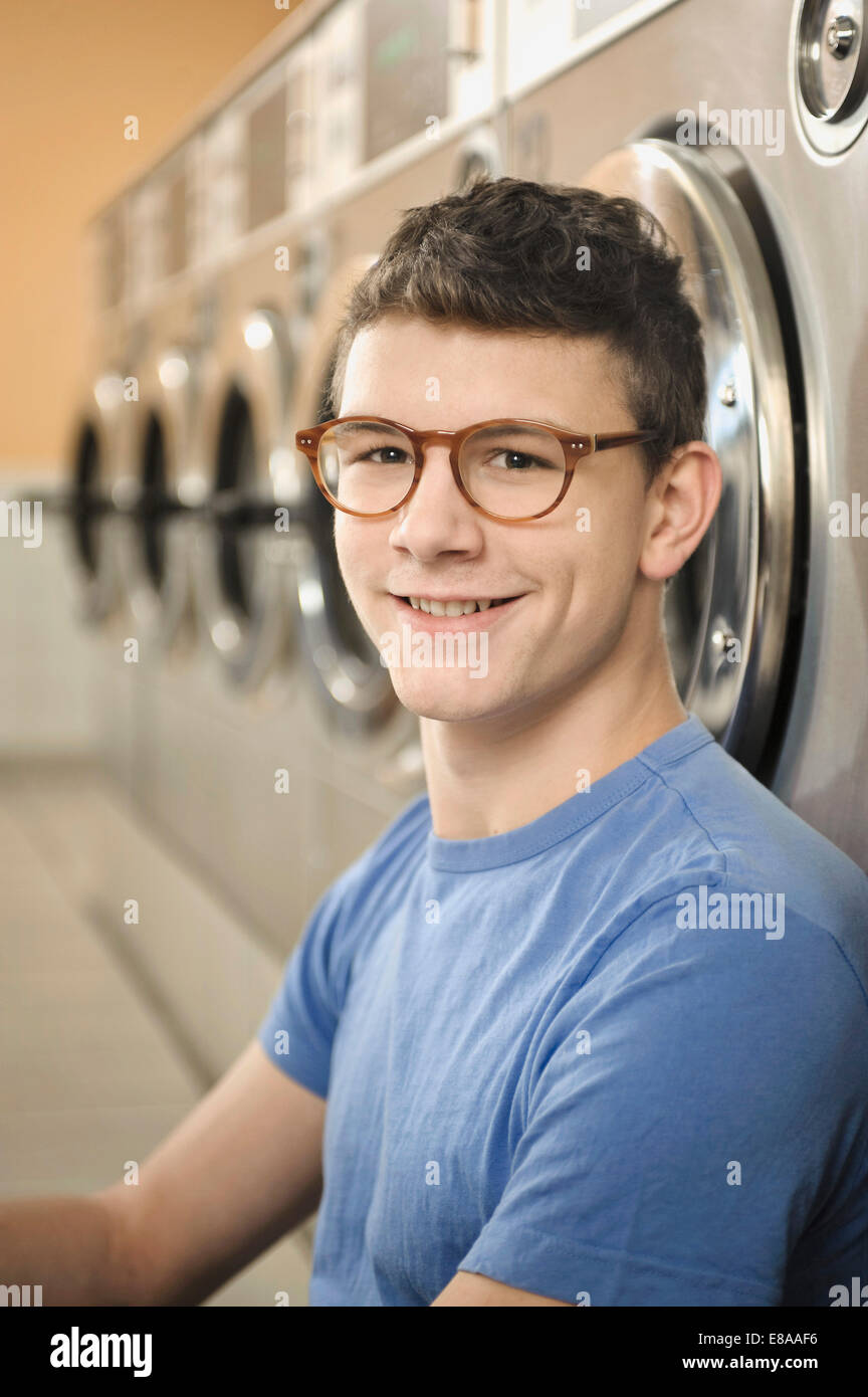 Portrait of young man waiting in laundry hi-res stock photography and ...