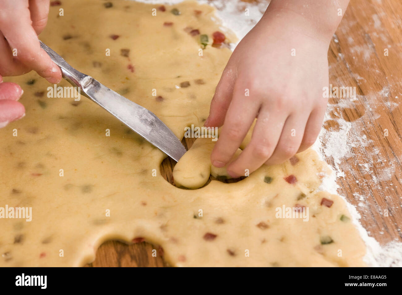 Human hand cutting dough with knife for cookies, close up Stock Photo ...