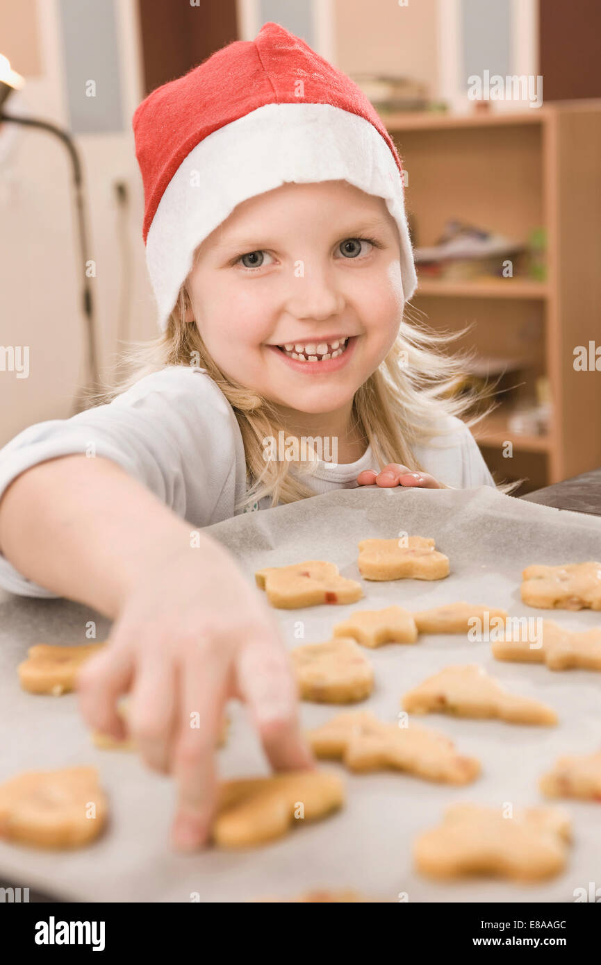 Girl baking cookies, smiling, portrait Stock Photo - Alamy