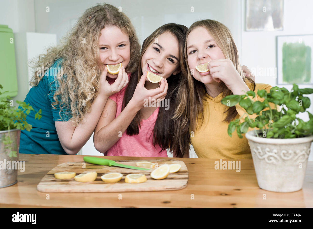 girls in kitchen goofing around with lemons Stock Photo - Alamy