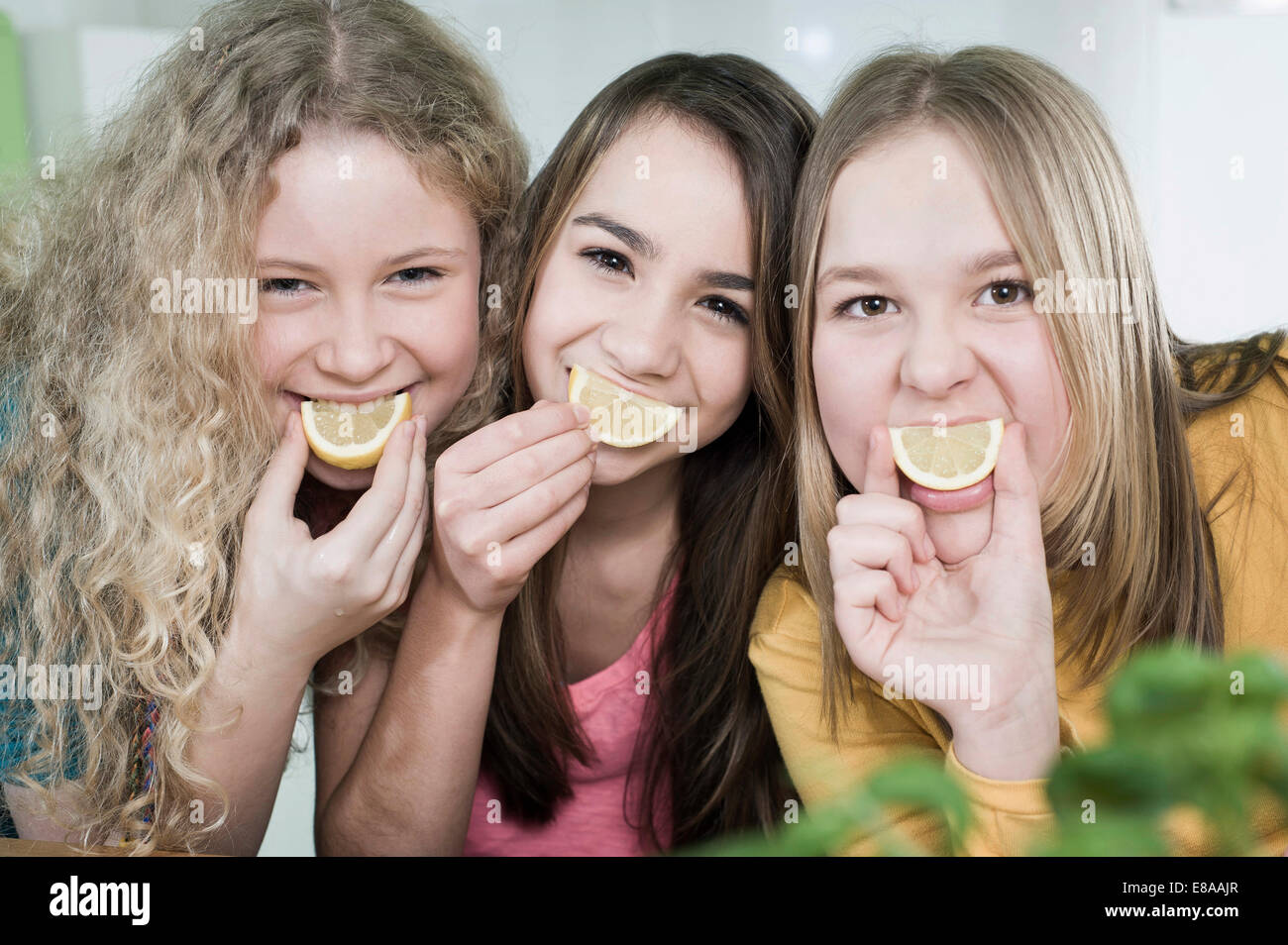 girls in kitchen goofing around with lemons Stock Photo - Alamy