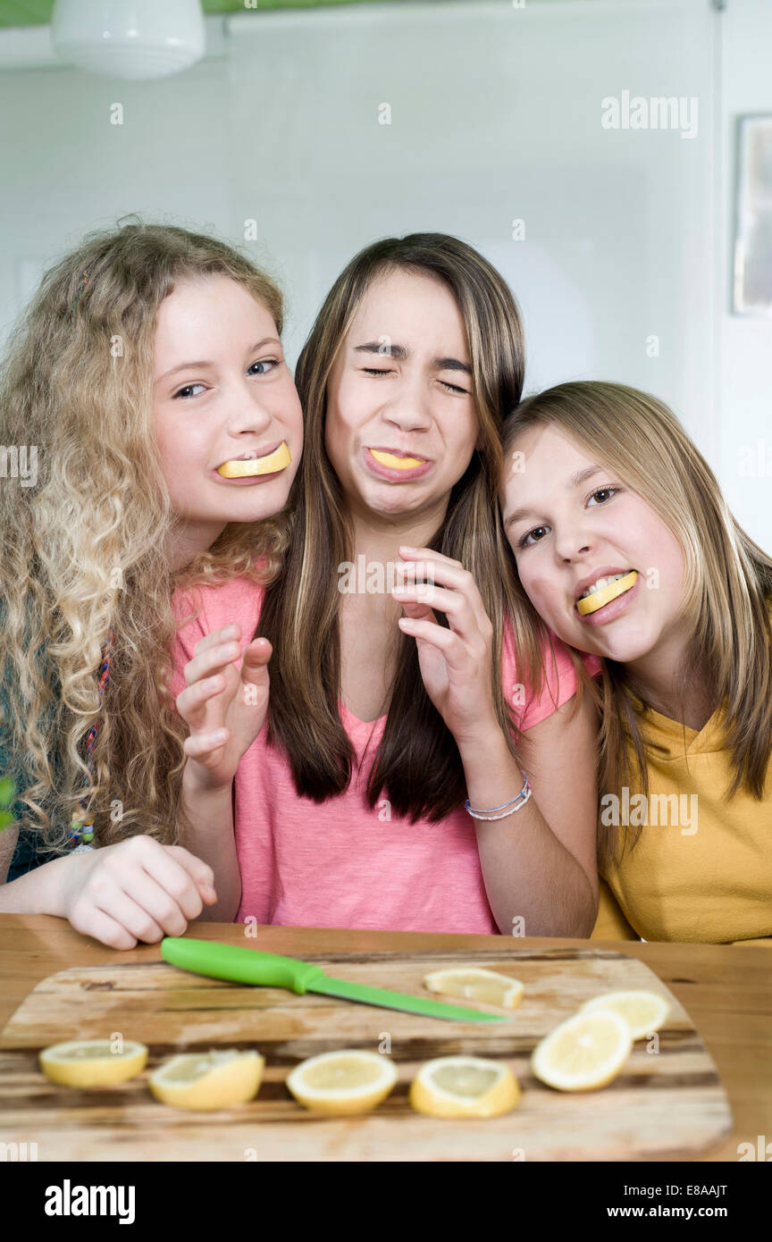 girls in kitchen goofing around with lemons Stock Photo - Alamy