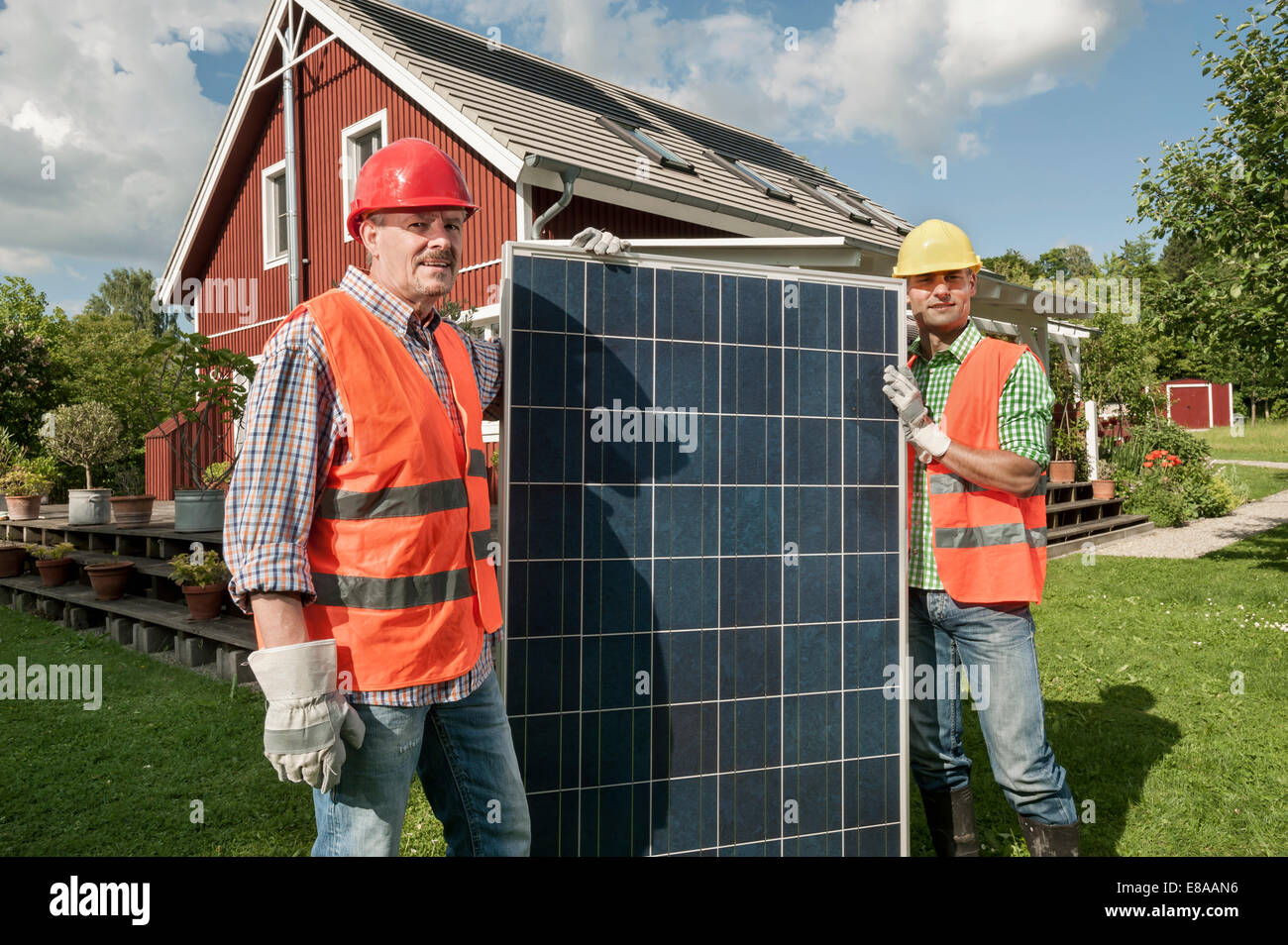 Solar panel delivery house workmen garden Stock Photo - Alamy