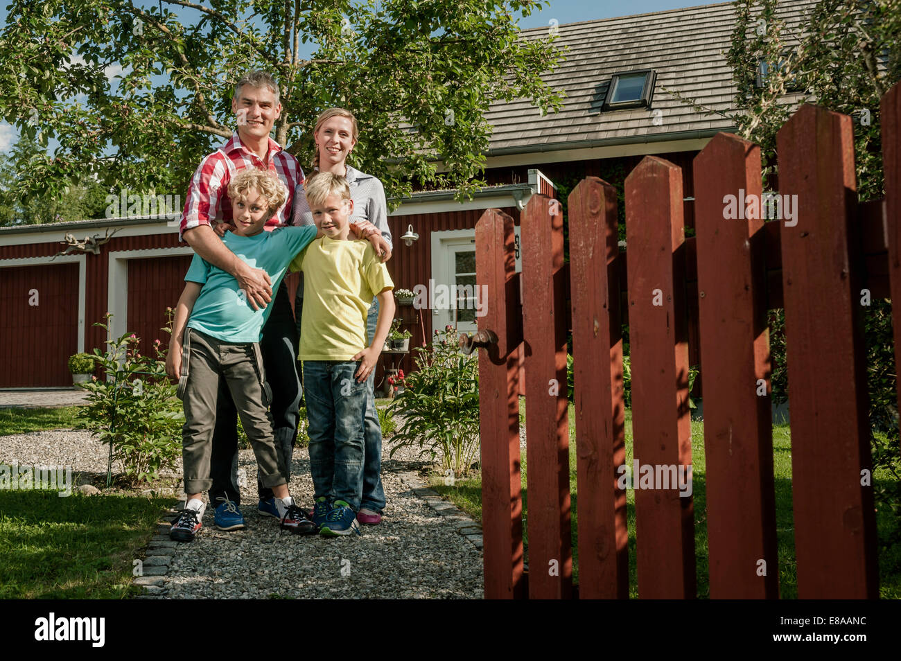 Young family standing garden gate new home Stock Photo - Alamy