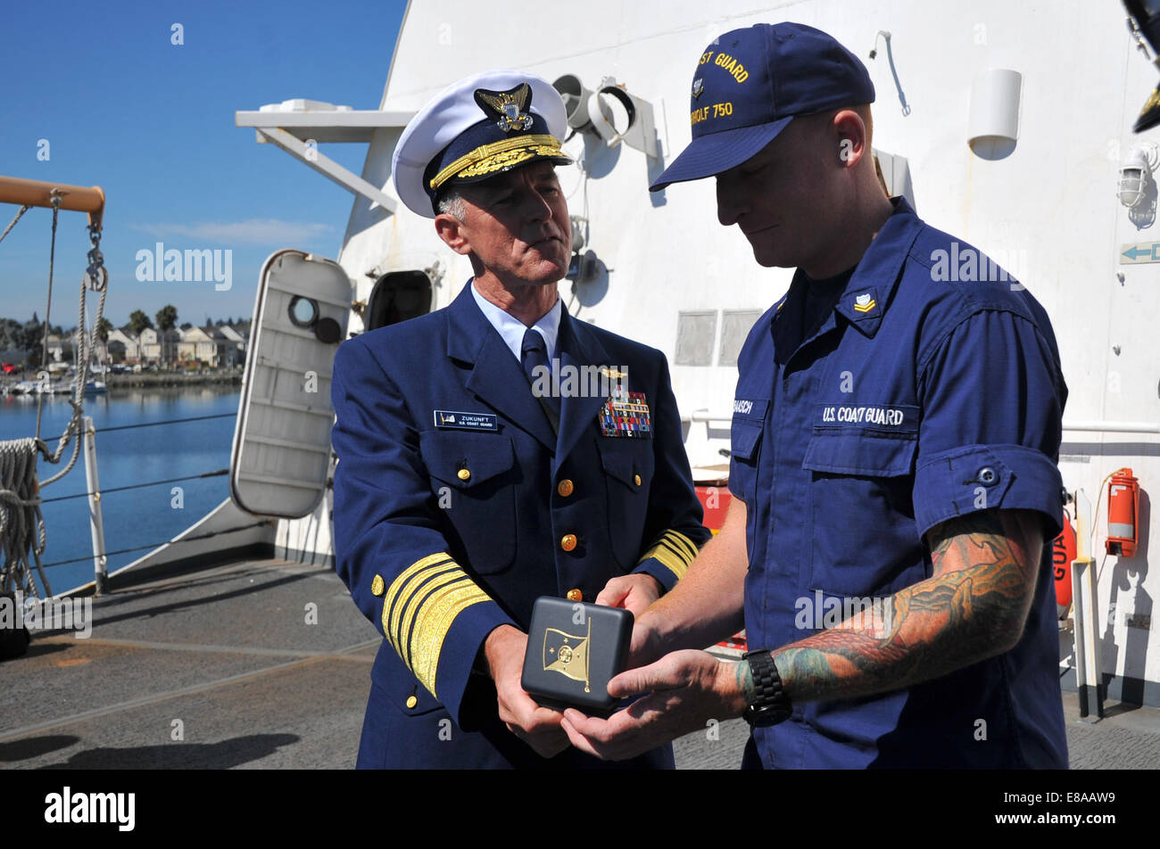 Commandant of the U.S. Coast Guard Adm. Paul Zukunft, left, recognizes ...