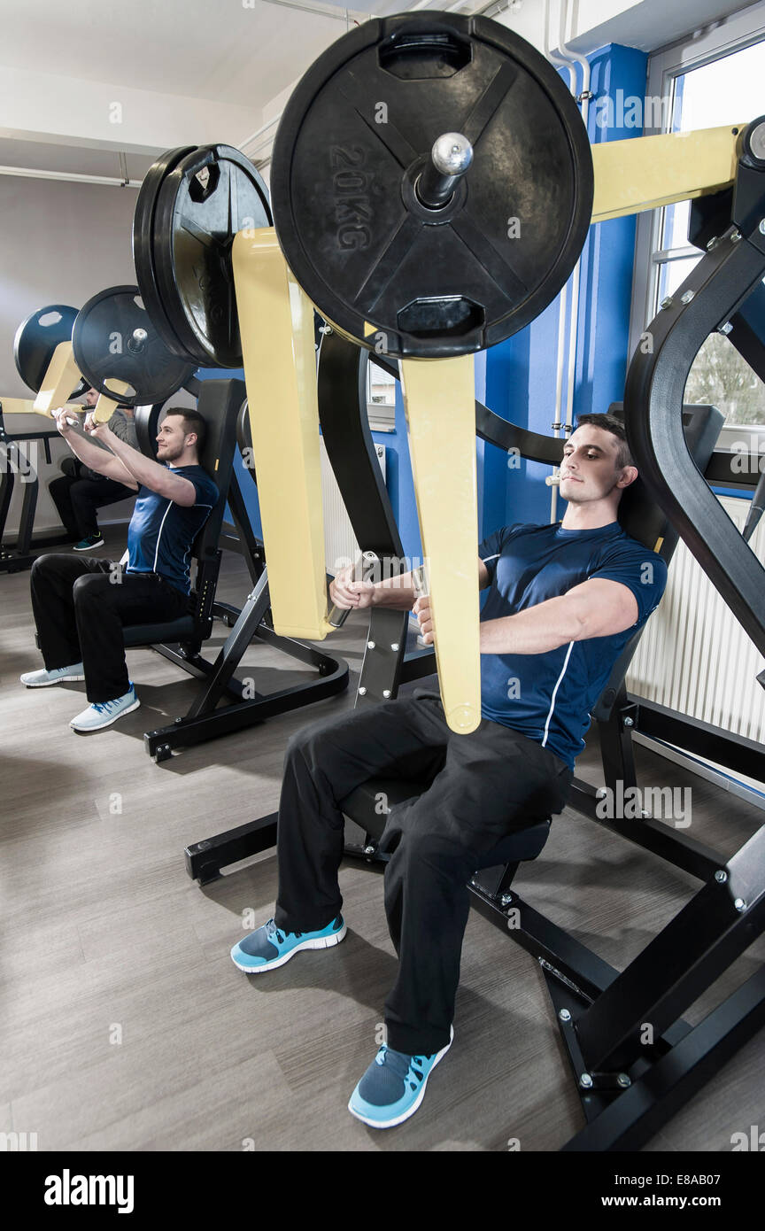 Two young men in gym doing weight training Stock Photo - Alamy