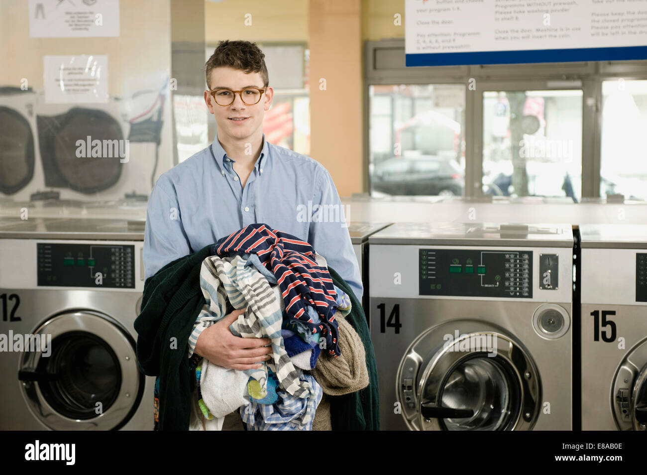 Portrait of young man with laundry hi-res stock photography and images ...