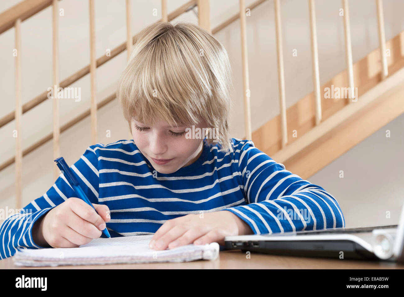 Boy doing his homework Stock Photo - Alamy