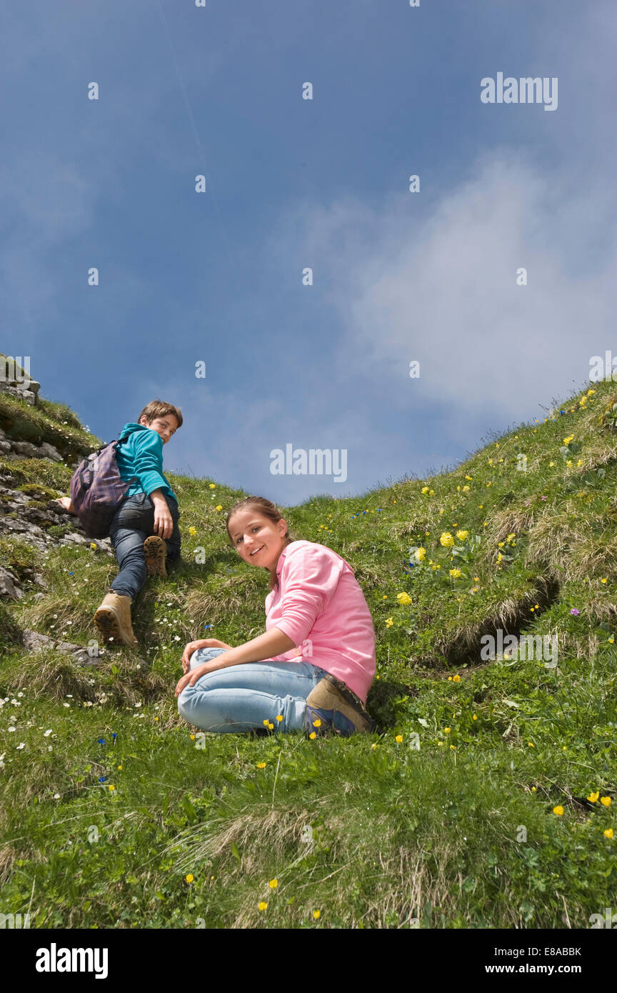 Young girl sitting on grass hi-res stock photography and images - Alamy