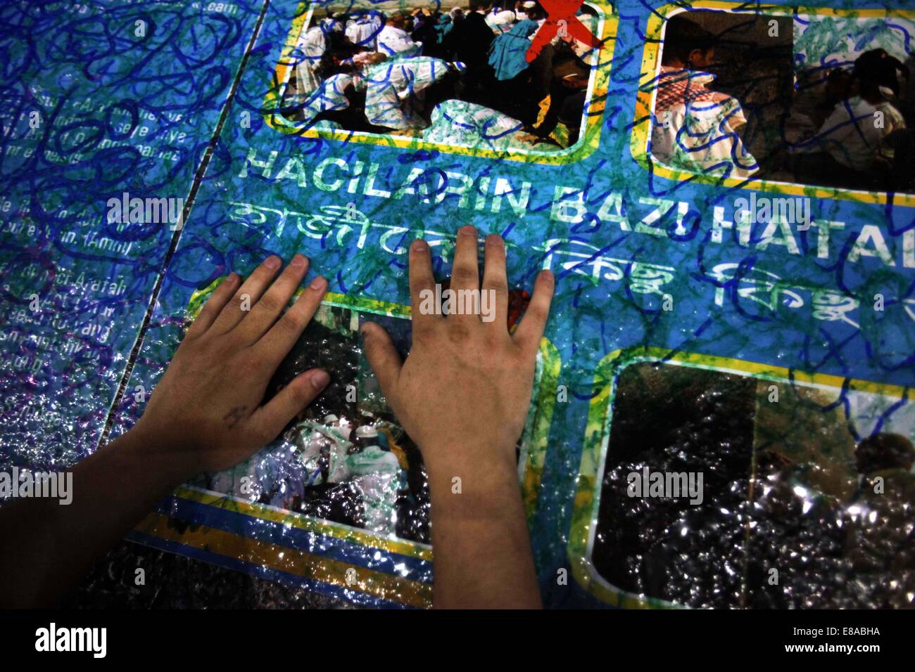 Mecca, Saudi Arabia. 3rd Oct, 2014. Muslim pilgrims touch a rock as ...