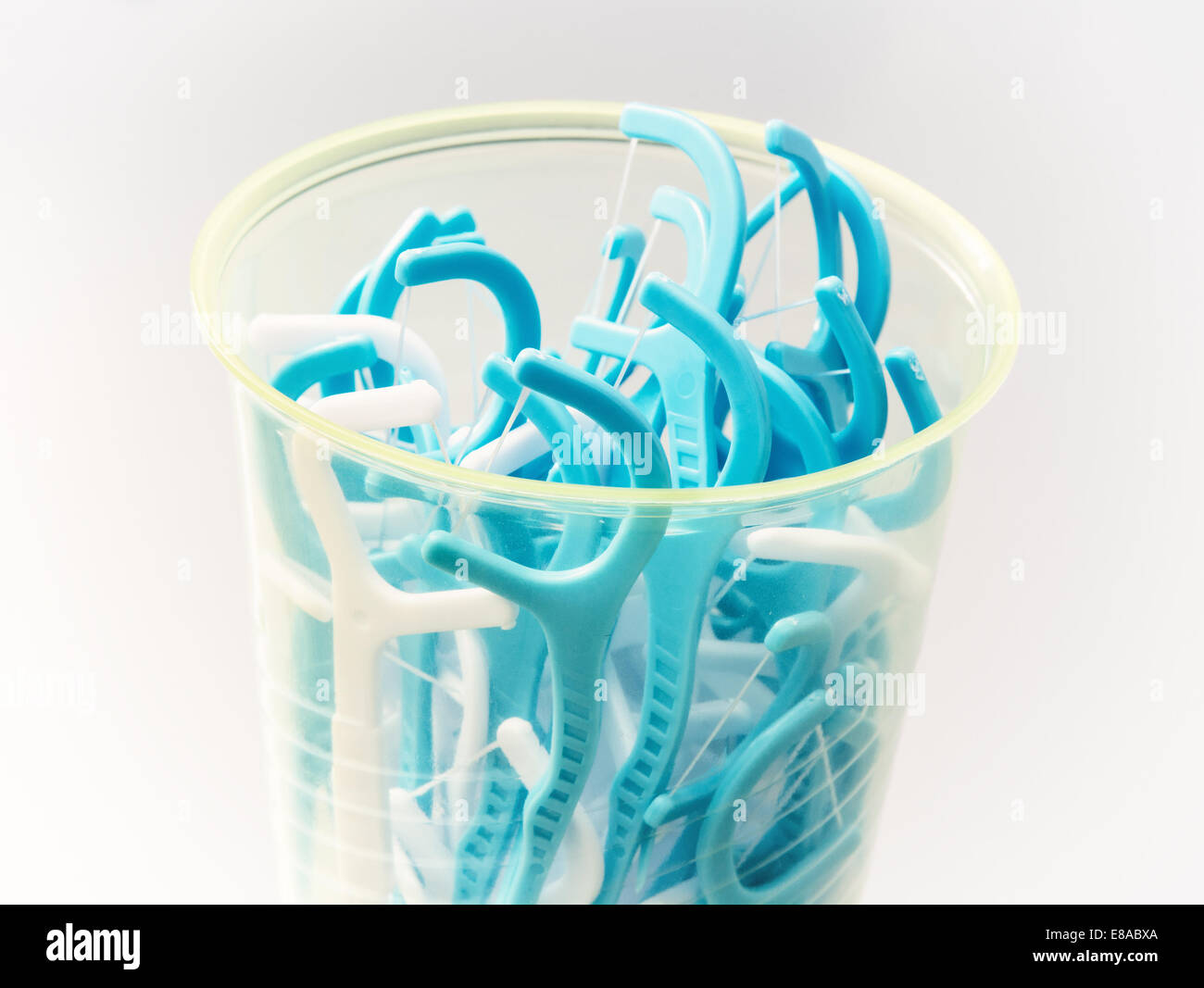 Blue dental floss sticks in plastic cup on a white background Stock ...