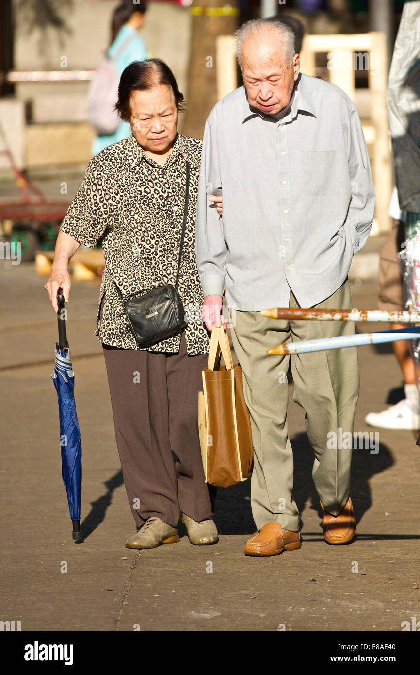 Helping elderly cross street hi-res stock photography and images - Alamy