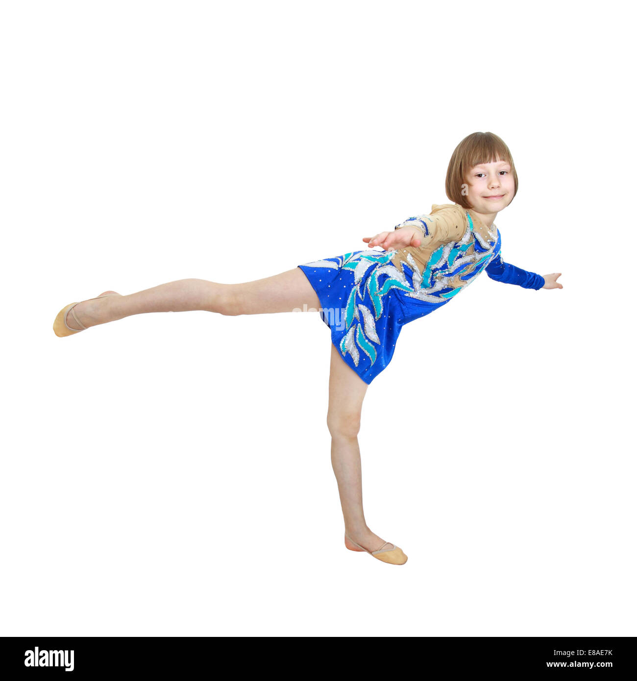 Girl stands in gymnastic exercise position isolated on white background ...