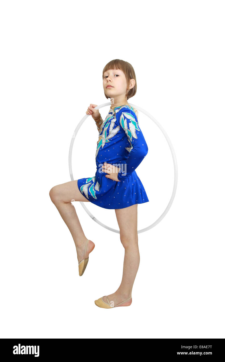 Girl in gymnast suit stands on one leg and hold gymnastic hoop in hand ...